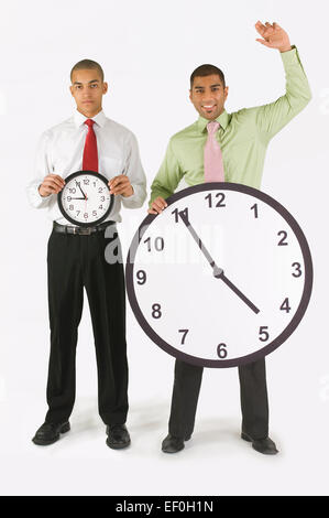 Man holding clock with arms outstretched Stock Photo - Alamy