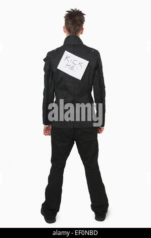 Businessman with kick me sign on his back Stock Photo - Alamy