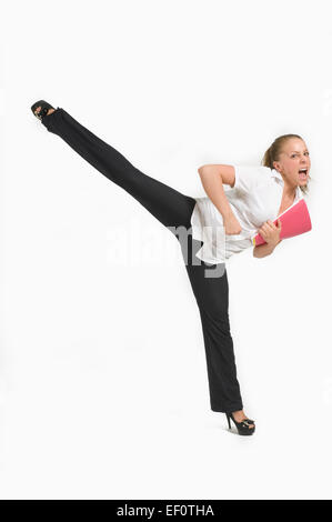 Woman kicking her leg in the air Stock Photo - Alamy