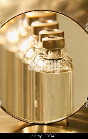 Row of medical glass vial with solution for injection on white ...