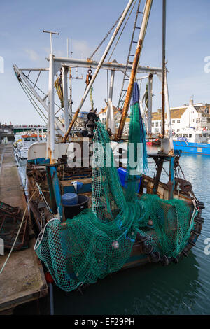 fishing boat commercial trawler with green nets out of water and up on ...