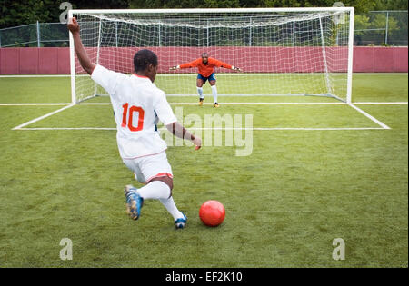 Football player ready to kicks the soccer ball at the stadium Stock ...