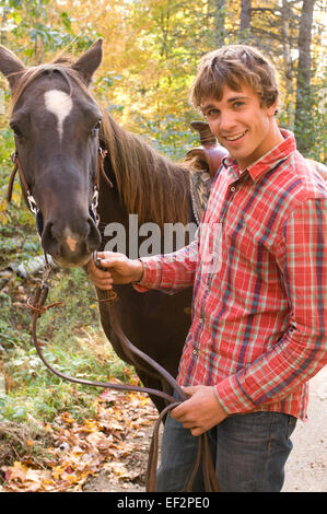 Young Man Rider With Her Horse Enjoying Good Mood in Evening Sunset ...