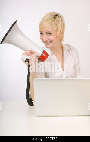 Blond woman holding a bullhorn Stock Photo - Alamy