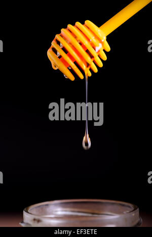 Drops of honey on a light background Stock Photo - Alamy