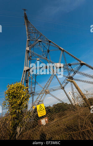 A metal electricity pylon (UK) showing danger signs. Also known as a ...