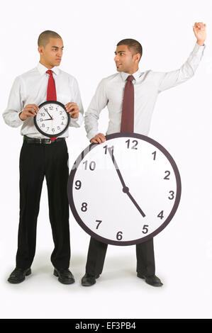 Man holding clock with arms outstretched Stock Photo - Alamy