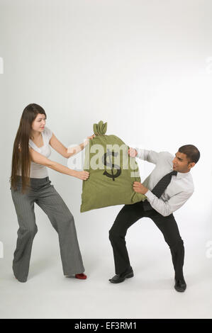 Business people fighting over money or stretching dollar currency Stock ...