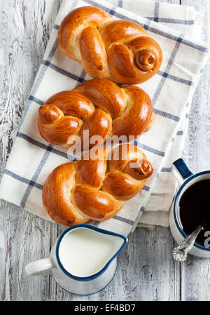 Closeup of sweet buns, coffee and milk, fall decorations Stock Photo ...