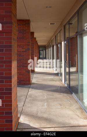 Building pillars outside corridor and glass doors. Corridor of brick ...