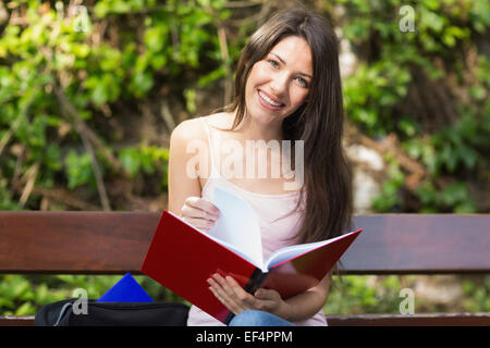 On campus - pretty, female student with books Stock Photo - Alamy