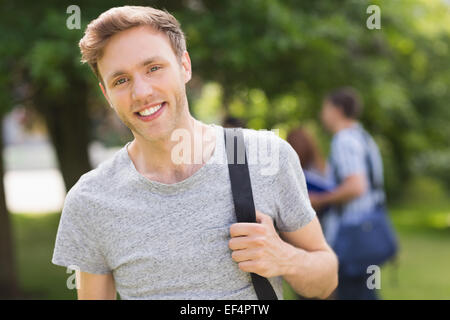 Handsome student smiling at camera outside Stock Photo - Alamy