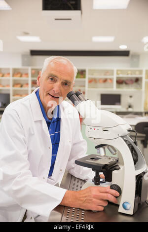 Medical professor working with microscope Stock Photo - Alamy