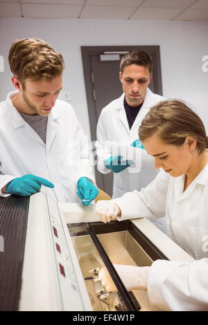 Woman, experiment and incubator in laboratory for science, control ...
