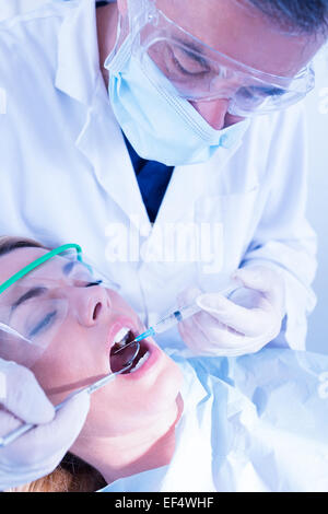 Dentist about to give injection to patient Stock Photo - Alamy