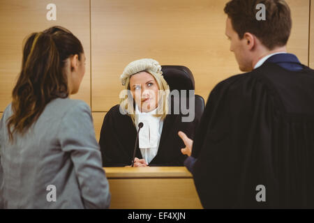 MALE FEMALE BARRISTER WEARING WIG GOWN LEAVING THE HIGH COURT LONDON ...
