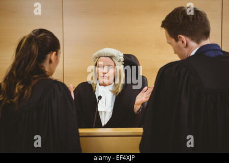 MALE FEMALE BARRISTER WEARING WIG GOWN LEAVING THE HIGH COURT LONDON ...
