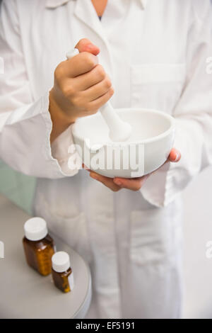 Young woman pharmacist mixing medicine at pharmacy Stock Photo - Alamy