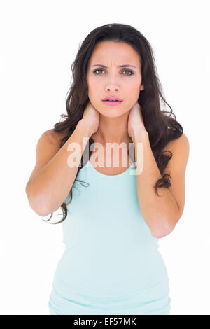 Pretty brunette with a sore neck Stock Photo - Alamy