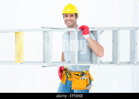Confident worker carrying step ladder Stock Photo - Alamy