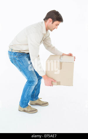 Delivery man picking cardboard box Stock Photo - Alamy