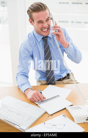 Frustrated man using a smart phone voice recognition function skeptical ...
