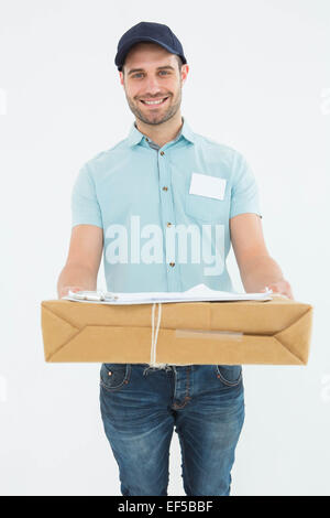 Young courier with parcel on white background Stock Photo - Alamy