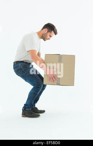 Courier man picking up cardboard box Stock Photo - Alamy