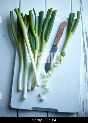 Chopped spring onions on a white board Stock Photo - Alamy