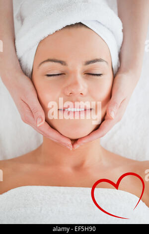 Young woman having facial massage with stone sticks in spa salon Stock ...
