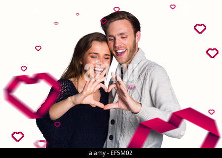 Composite image of happy couple forming heart with hands Stock Photo ...