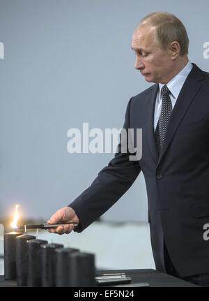 Russian President Vladimir Putin lights a candle while visiting the ...