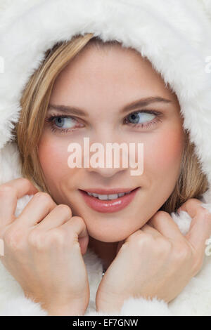 A vertical close-up shot of a beautiful red chameleon descending a tree ...