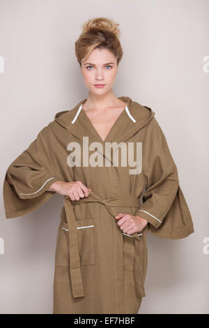 Beautiful young woman wearing bathrobe. Face care, Facial treatment ...