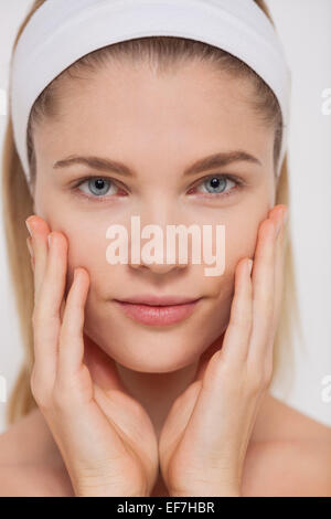 Woman Touching Cheeks Stock Photo - Alamy