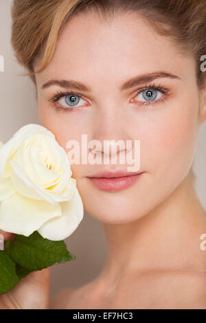 Woman touching her face Stock Photo - Alamy