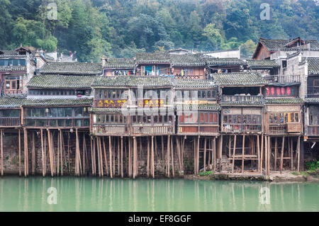 Wooden stilt houses on riverside, old town of Fenghuang, Hunan Province ...