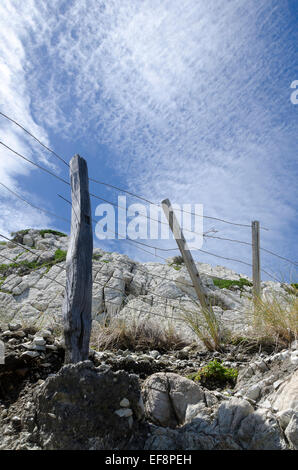 Fence on rocky cliff, White Rock, Wairarapa, North Island, New Zealand ...