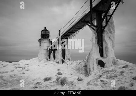 Ice covered St. Joseph pier light in winter. St. Joseph Michigan. On ...