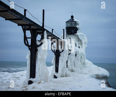 Ice covered St. Joseph pier light in winter. St. Joseph Michigan. On ...