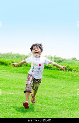 Child run. Excited kid boy running on grass. Kid boy playing and ...