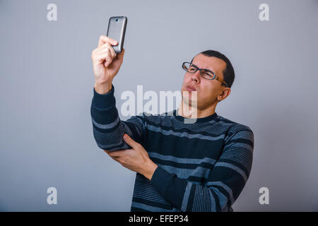 male of European appearance photographed on the phone a gray Stock ...