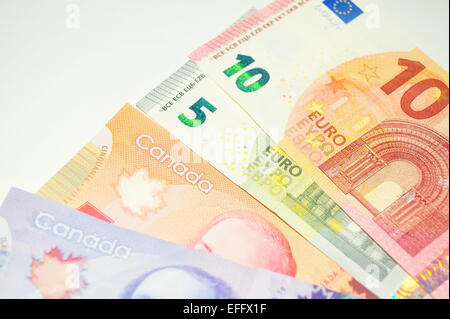 Canadian dollar notes and Euros photographed against a white background ...