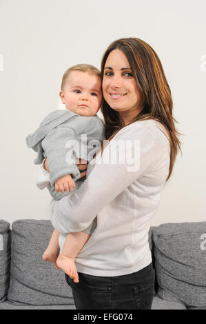 A Portrait of happy baby with cheerful mother at home bedroom Stock ...