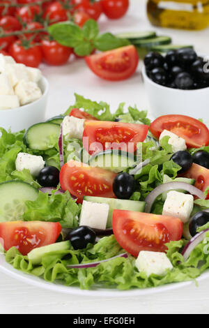 eating a Greek salad with feta cheese and pieces of dried rye bread ...