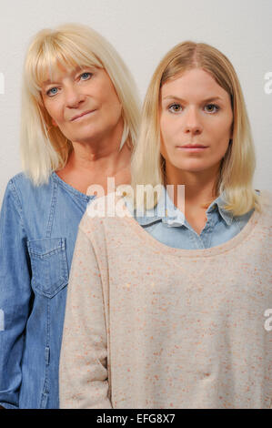 Smiling mother and adult daughter in park facing each other Stock Photo ...