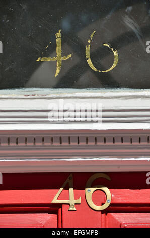 House number 46 with the forty-six in black on a silver letterbox set ...