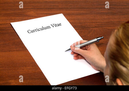 Young woman filling cv form on tablet computer, view from the back ...