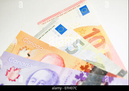 Canadian Dollar notes and European Euro notes photographed together ...