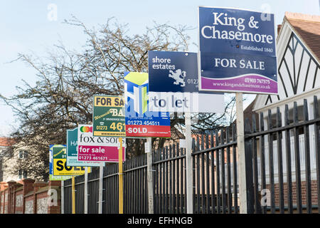 lots of estate agent boards for sale, sold, to let boards all lined up ...